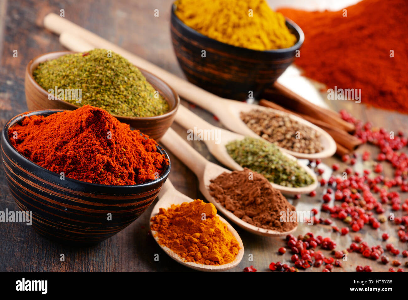Variety of spices on kitchen table Stock Photo - Alamy