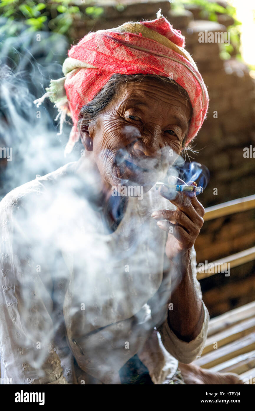 Myanmar (ex Birmanie). Inle lake. Woman smoking the cheroot the Burmese ...