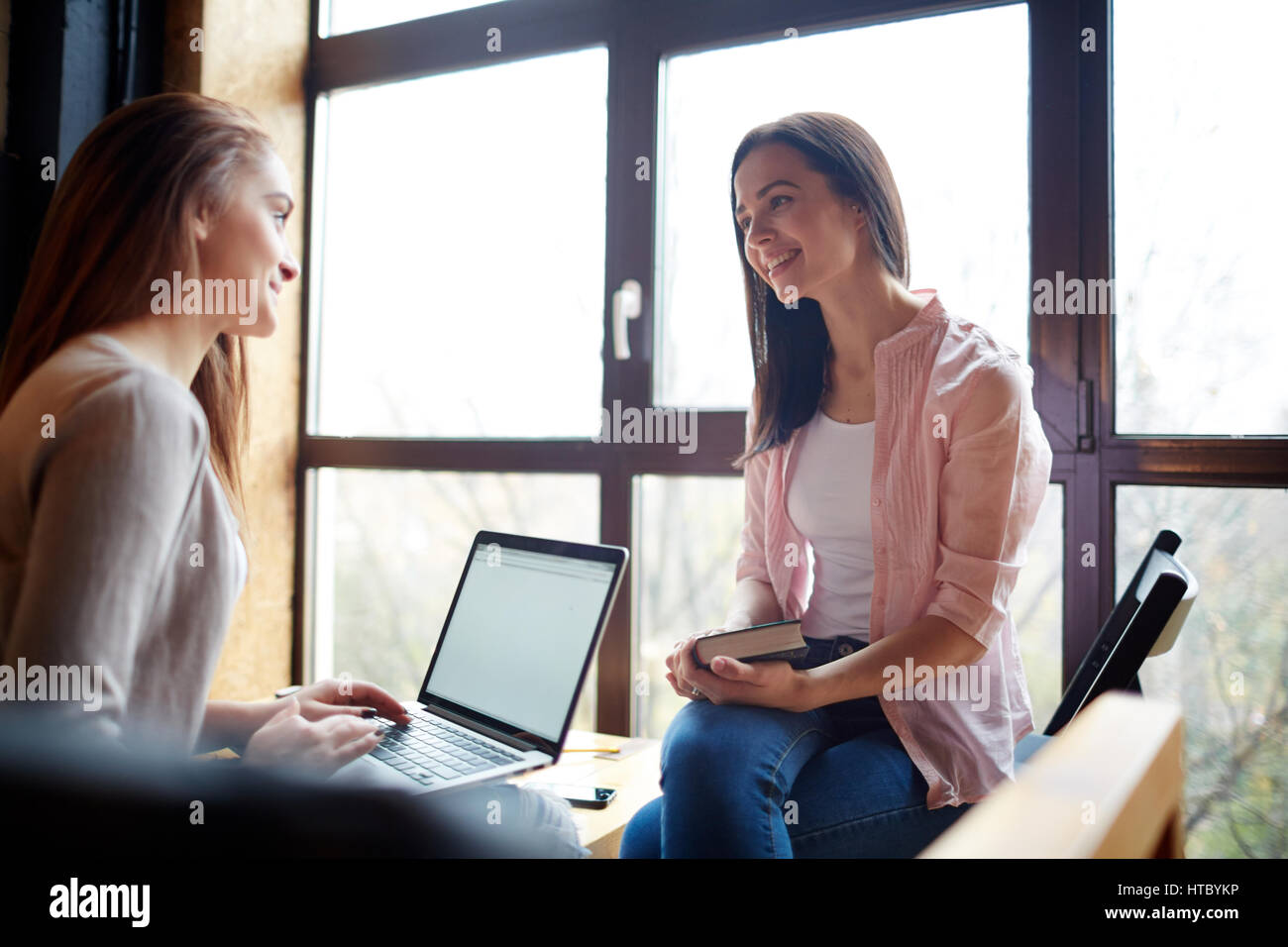 Happy teenage girls talking at break Stock Photo - Alamy