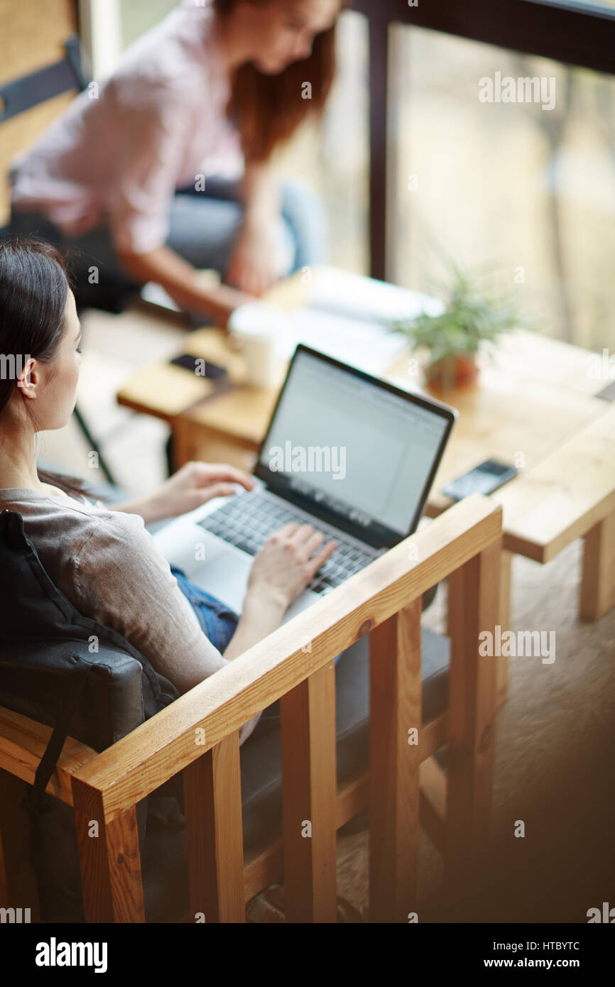 Mobile girl using wi-fi in cafe while networking Stock Photo - Alamy