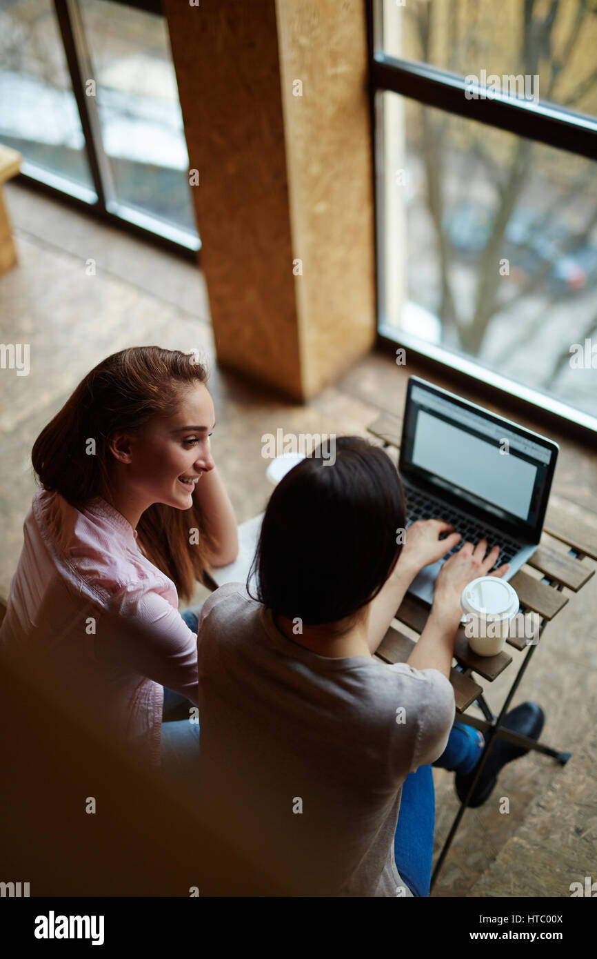 College buddies relaxing in cafe and browsing in the net Stock Photo ...