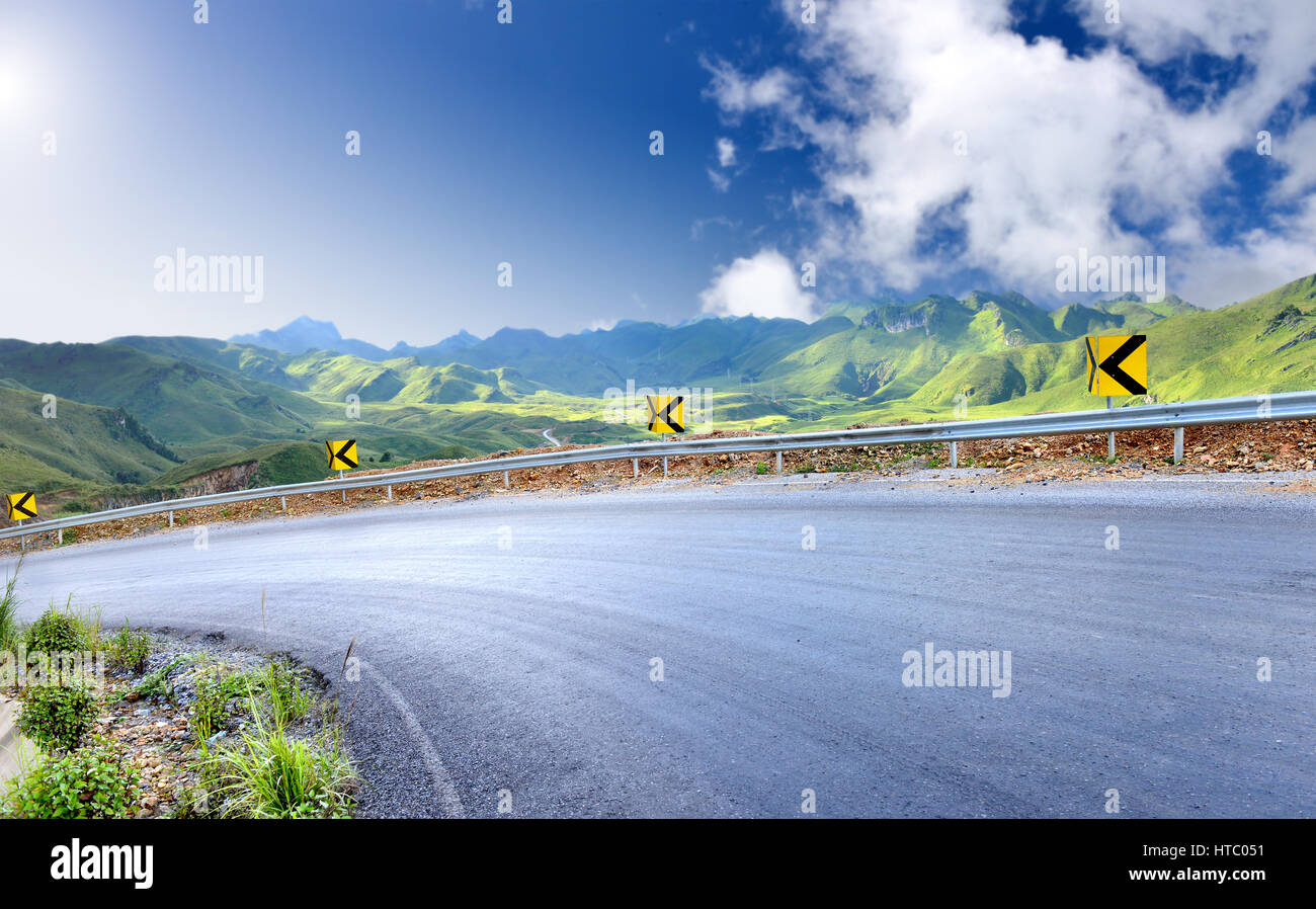 Mountain curve road and traffics sign in countryside of Lao in sunlight ...
