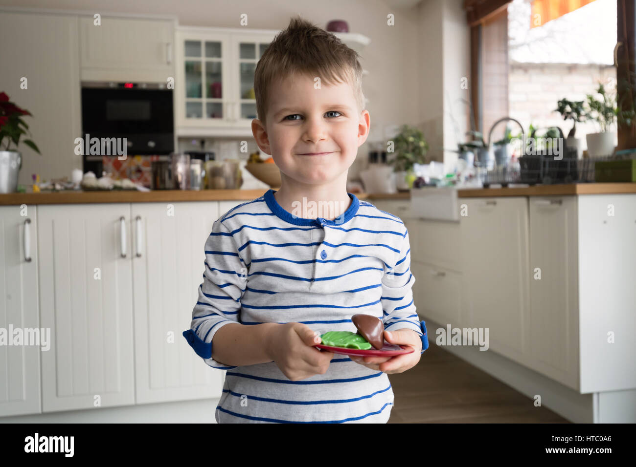 Happy young boy playing to be chef in kitchen Stock Photo - Alamy