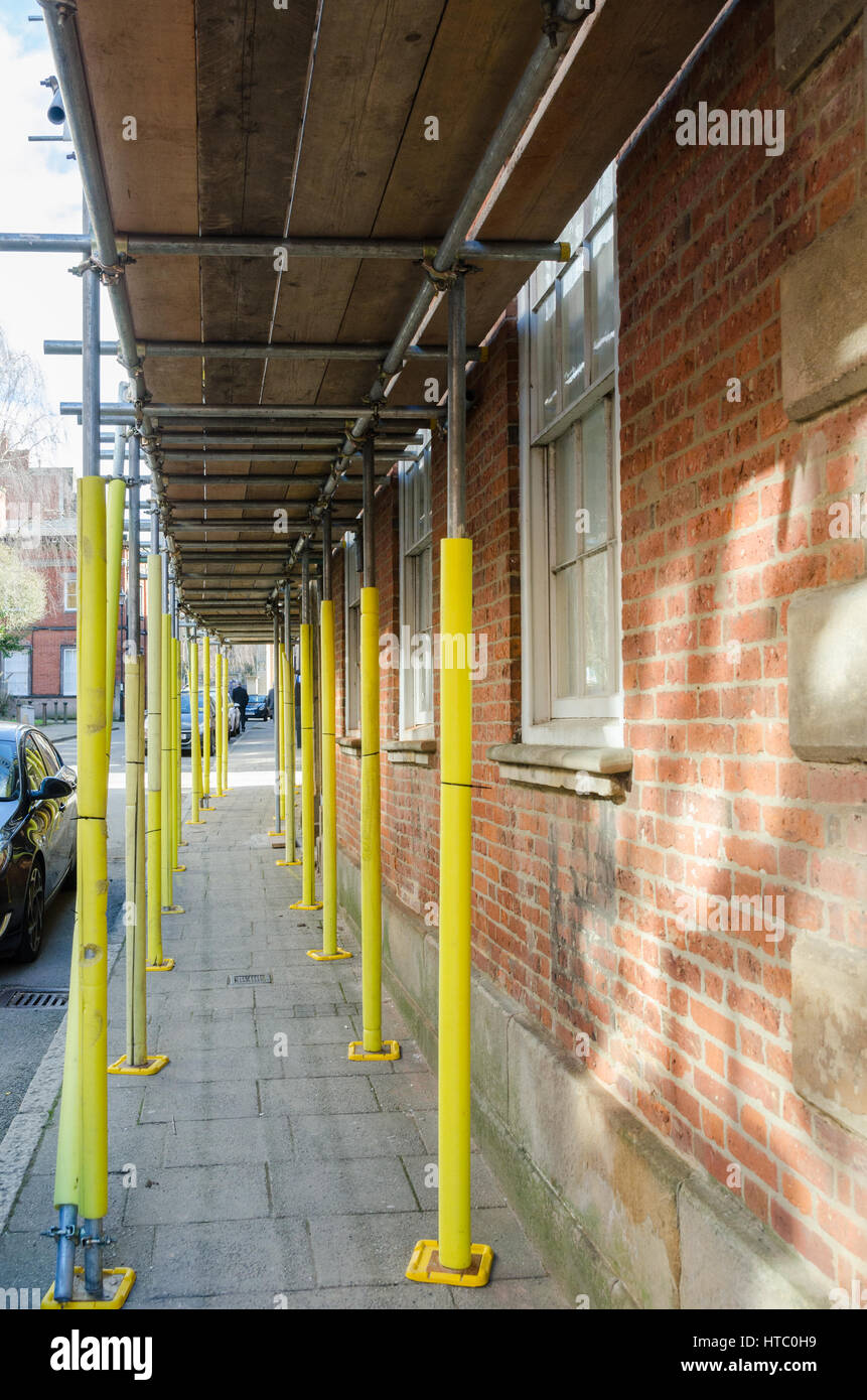 Scaffolding on the pavement outside an old building being restored with ...