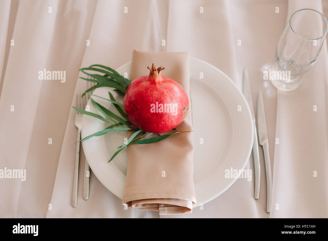 Beautifully decorated pomergranate with groom lable table sitting with ...