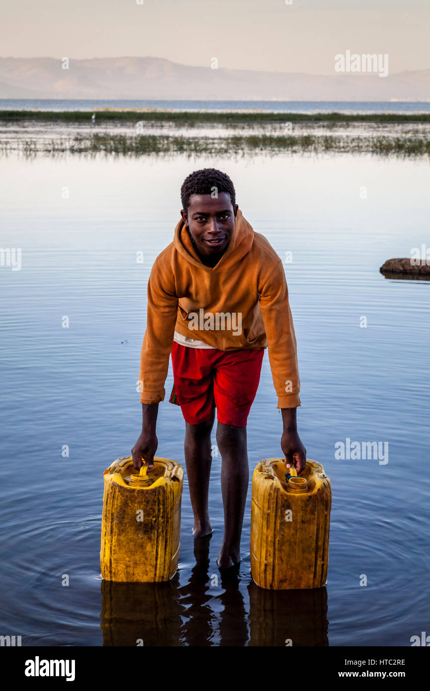 Boy fetching water hi-res stock photography and images - Alamy