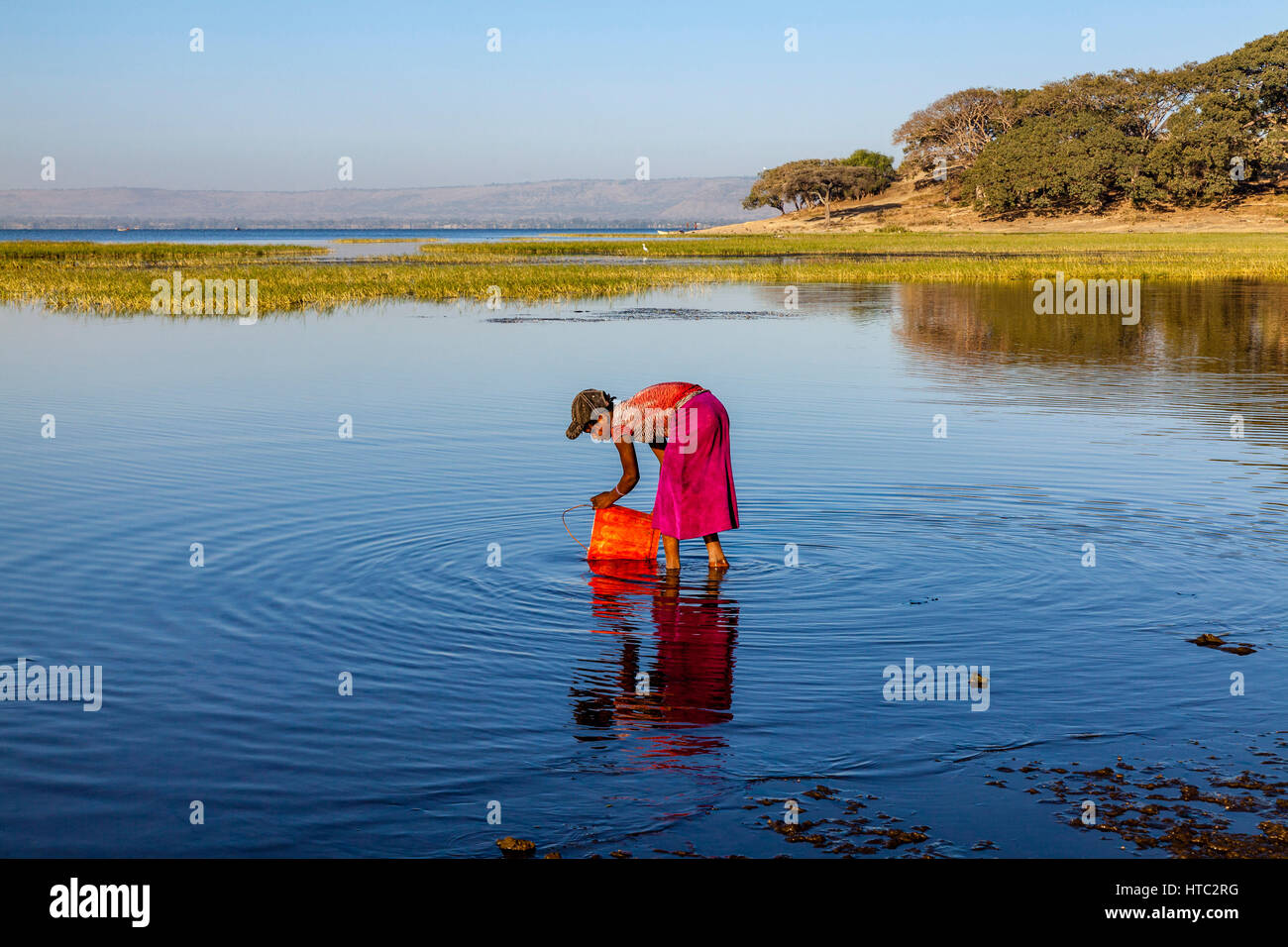 A Teenage Girl Collects Water From The Lake In A Bucket, Lake Awassa ...