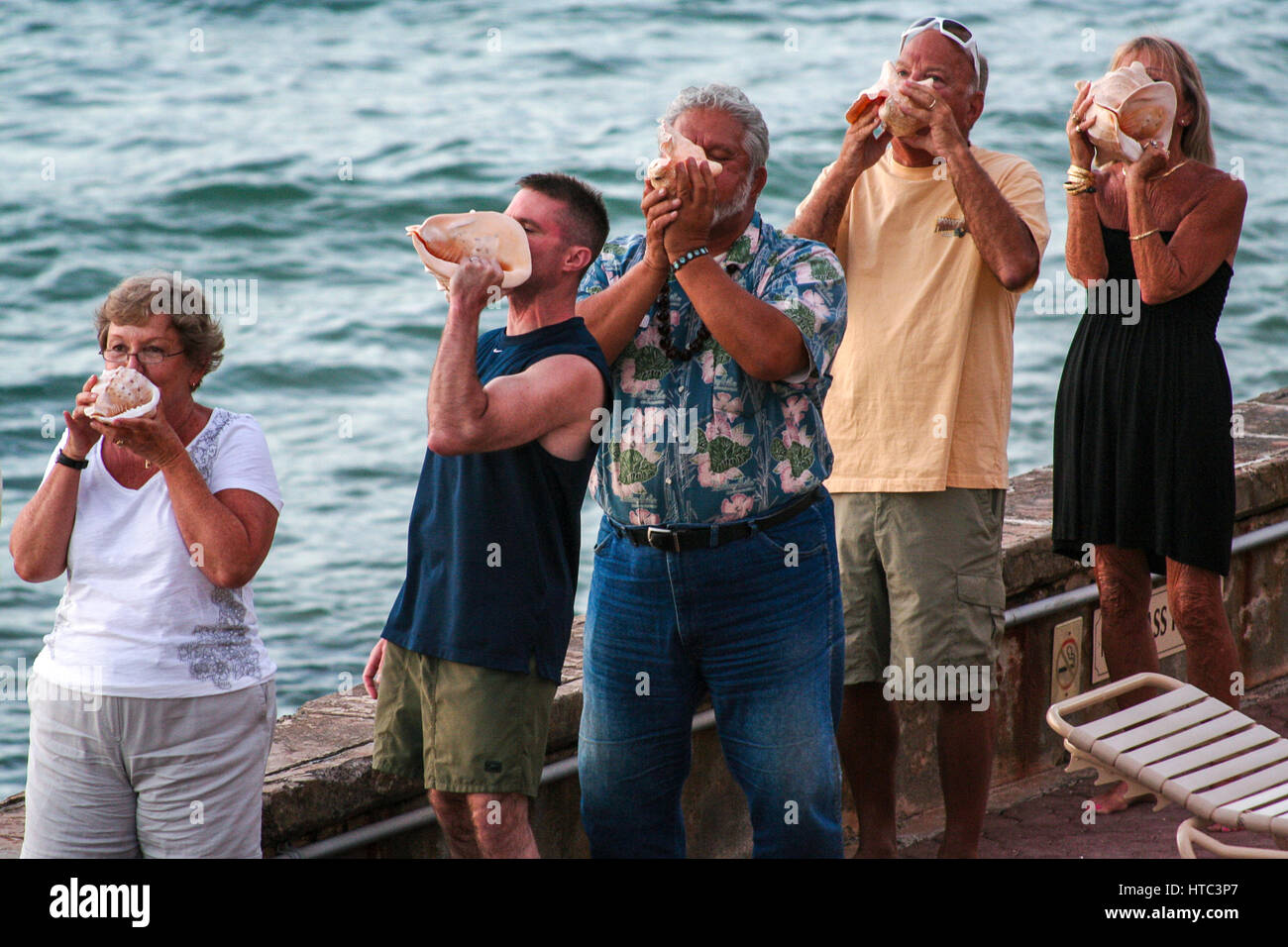 MAUI, HAWAII, MAY, 2011:A group of people blowing the conch to at ...