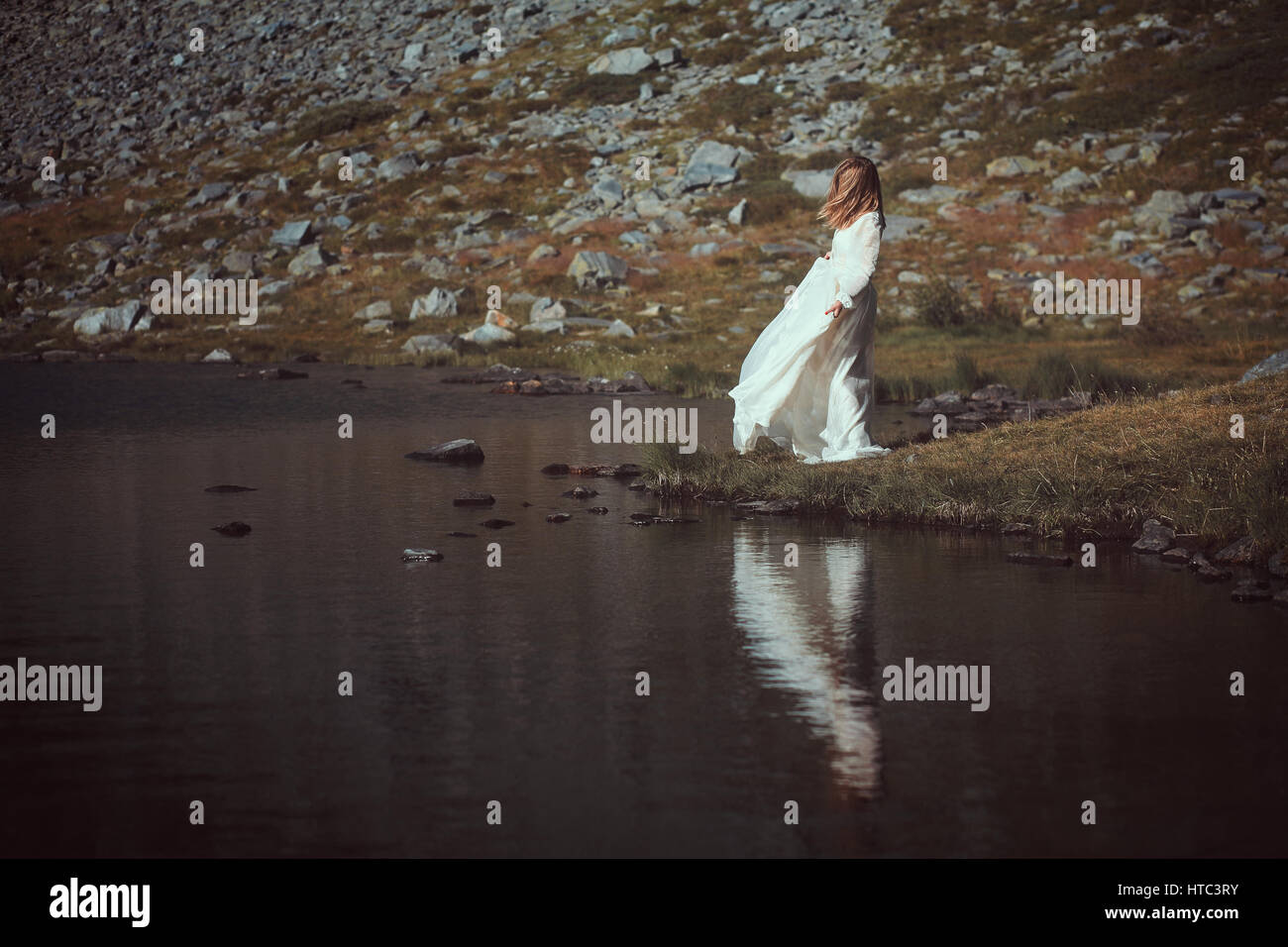 Lone woman in desolate lake . Sadness and loneliness Stock Photo - Alamy