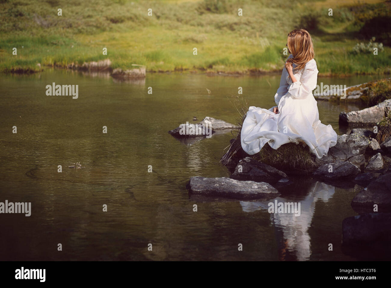 Woman seated on rocks hi-res stock photography and images - Alamy