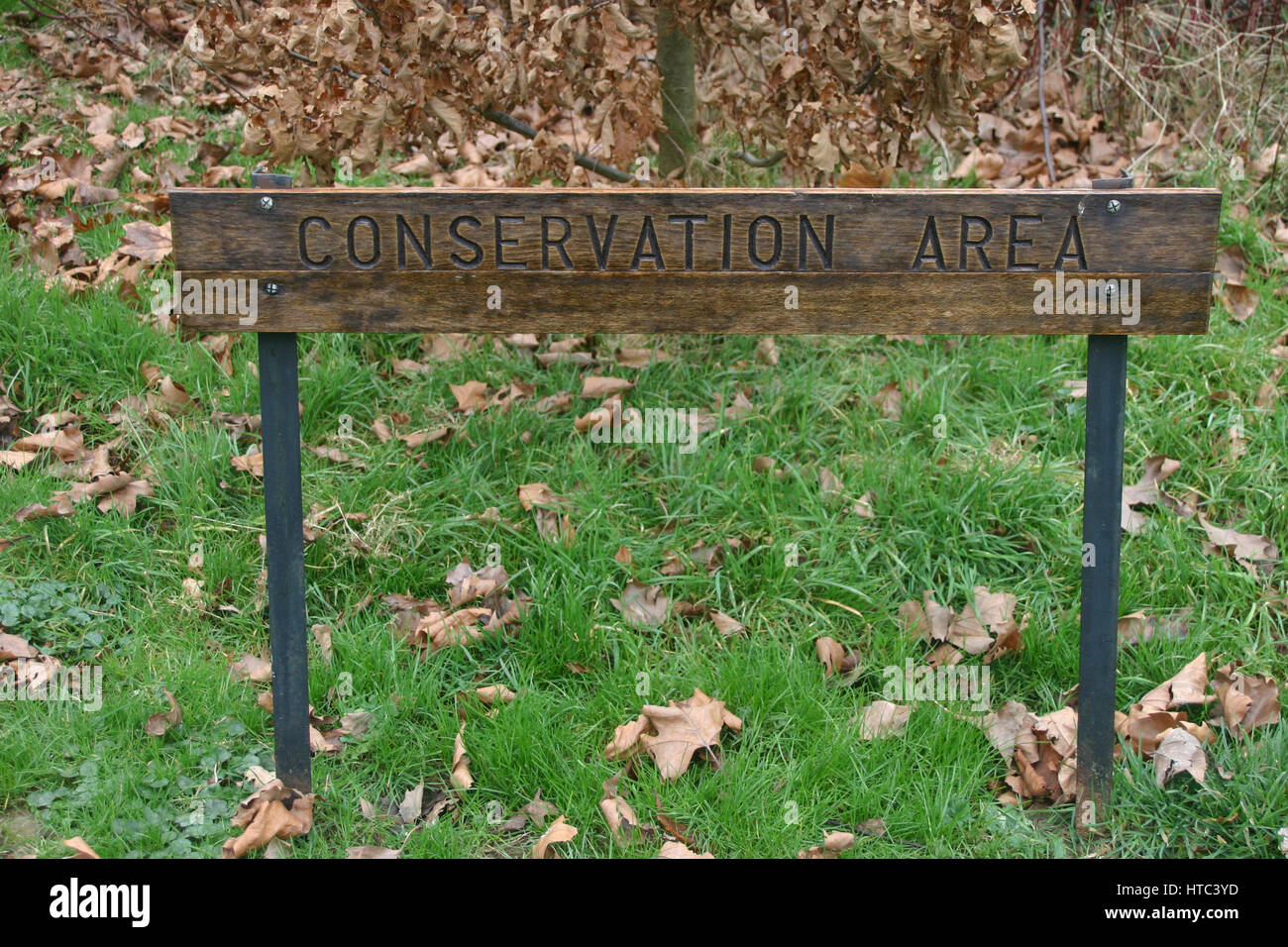 Wooden sign with the words "CONSERVATION AREA" attached to metal posts ...