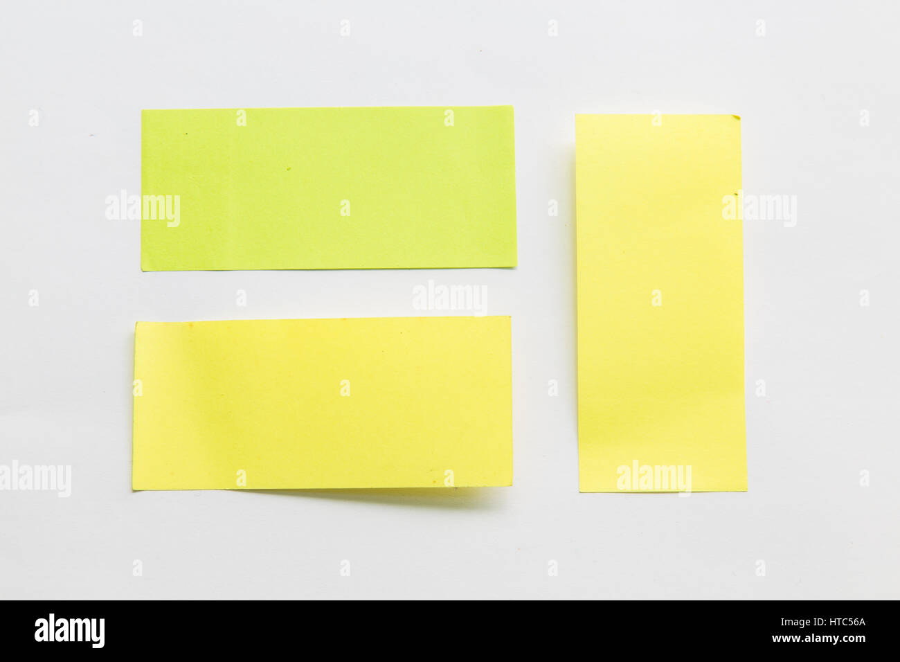 green and yellow post it paper note on white background Stock Photo - Alamy
