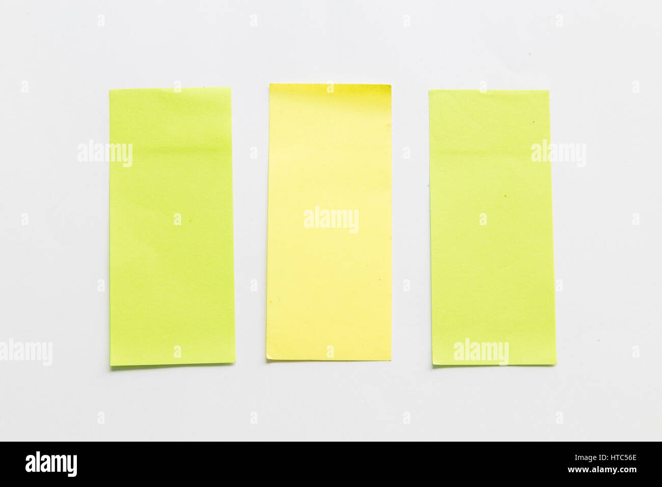 green and yellow post it paper note on white background Stock Photo - Alamy