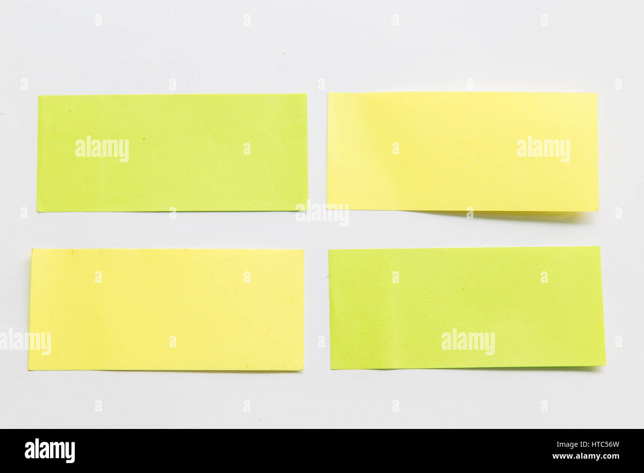 green and yellow post it paper note on white background Stock Photo - Alamy