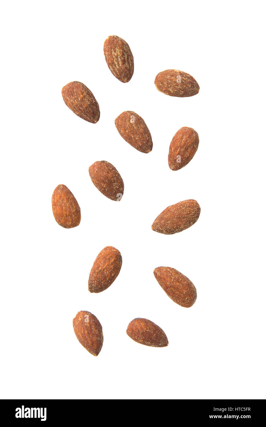 Almonds falling isolated on white background Stock Photo - Alamy
