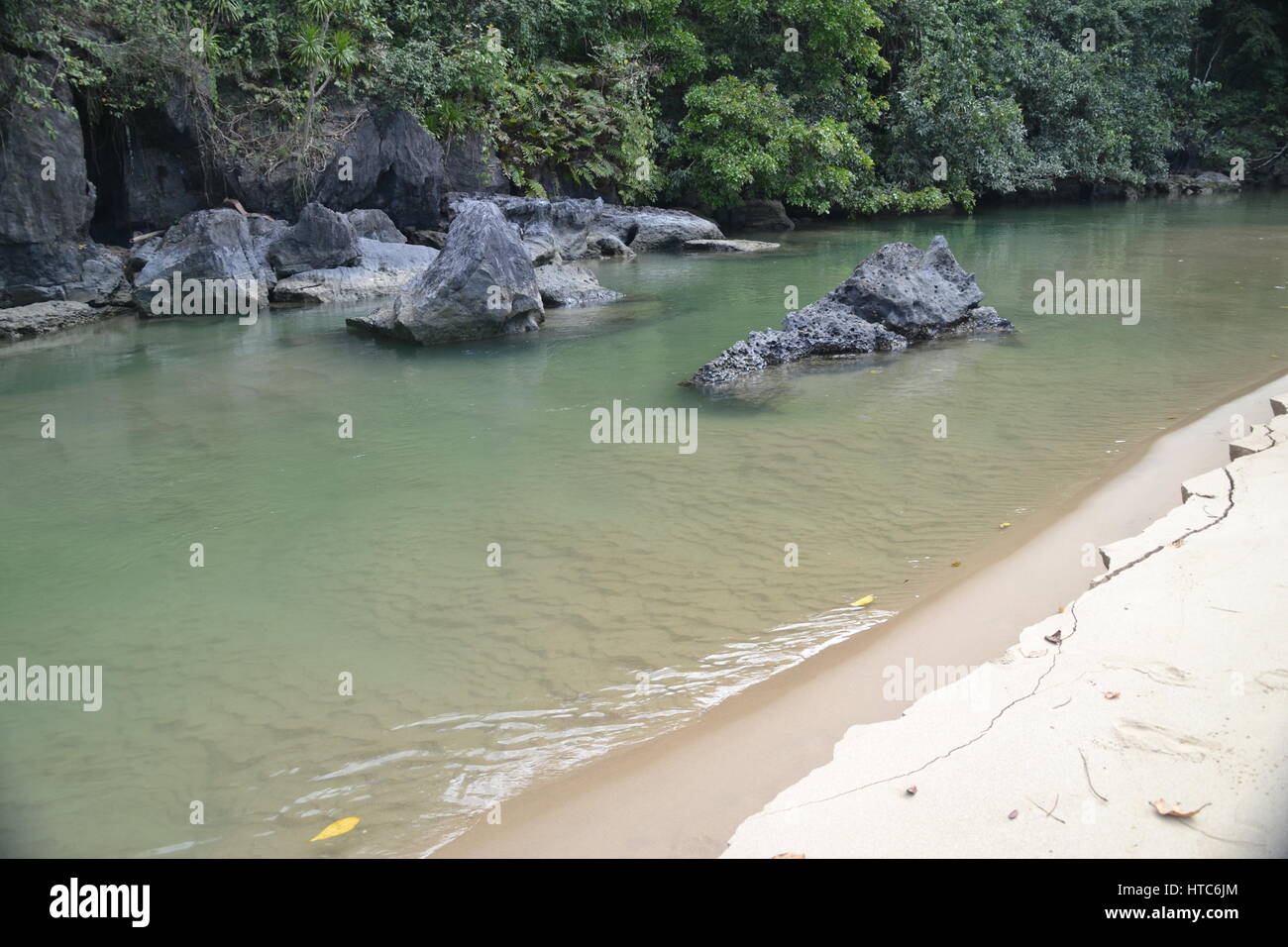 Philippines, Palawan, Sabang beach at Underground River. River is ...