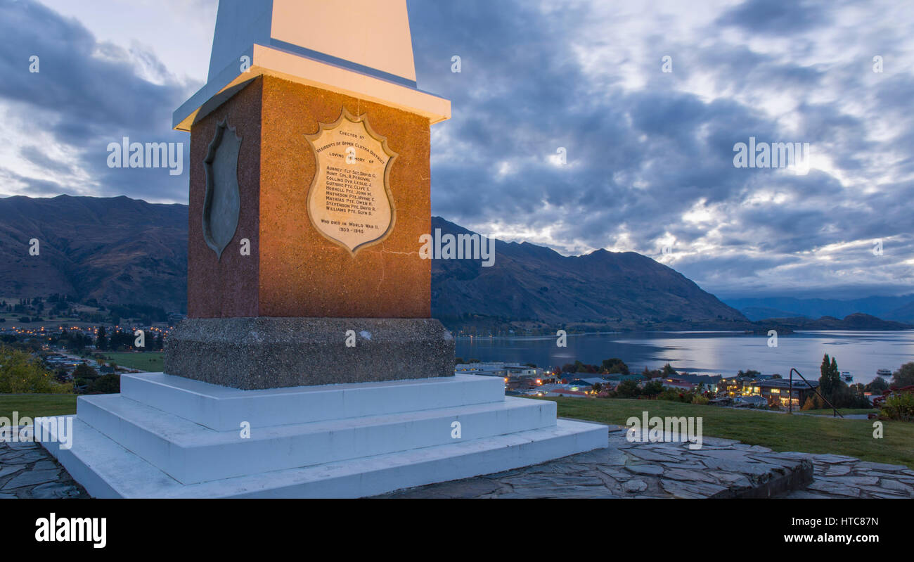 Wanaka, Otago, New Zealand. Illuminated war memorial on hilltop above ...