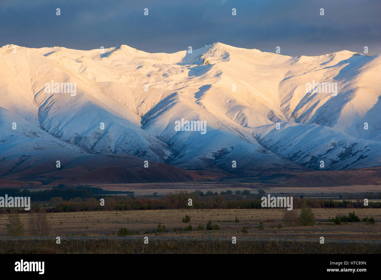 Twizel, Canterbury, New Zealand. The Ben Ohau Range cloaked in autumn ...