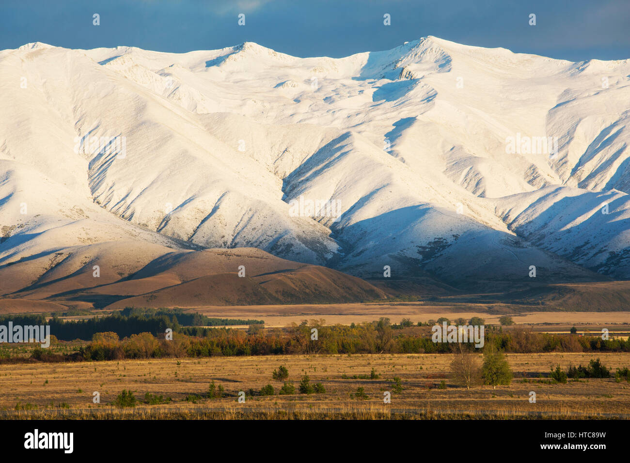 Twizel, Canterbury, New Zealand. The Ben Ohau Range cloaked in autumn ...