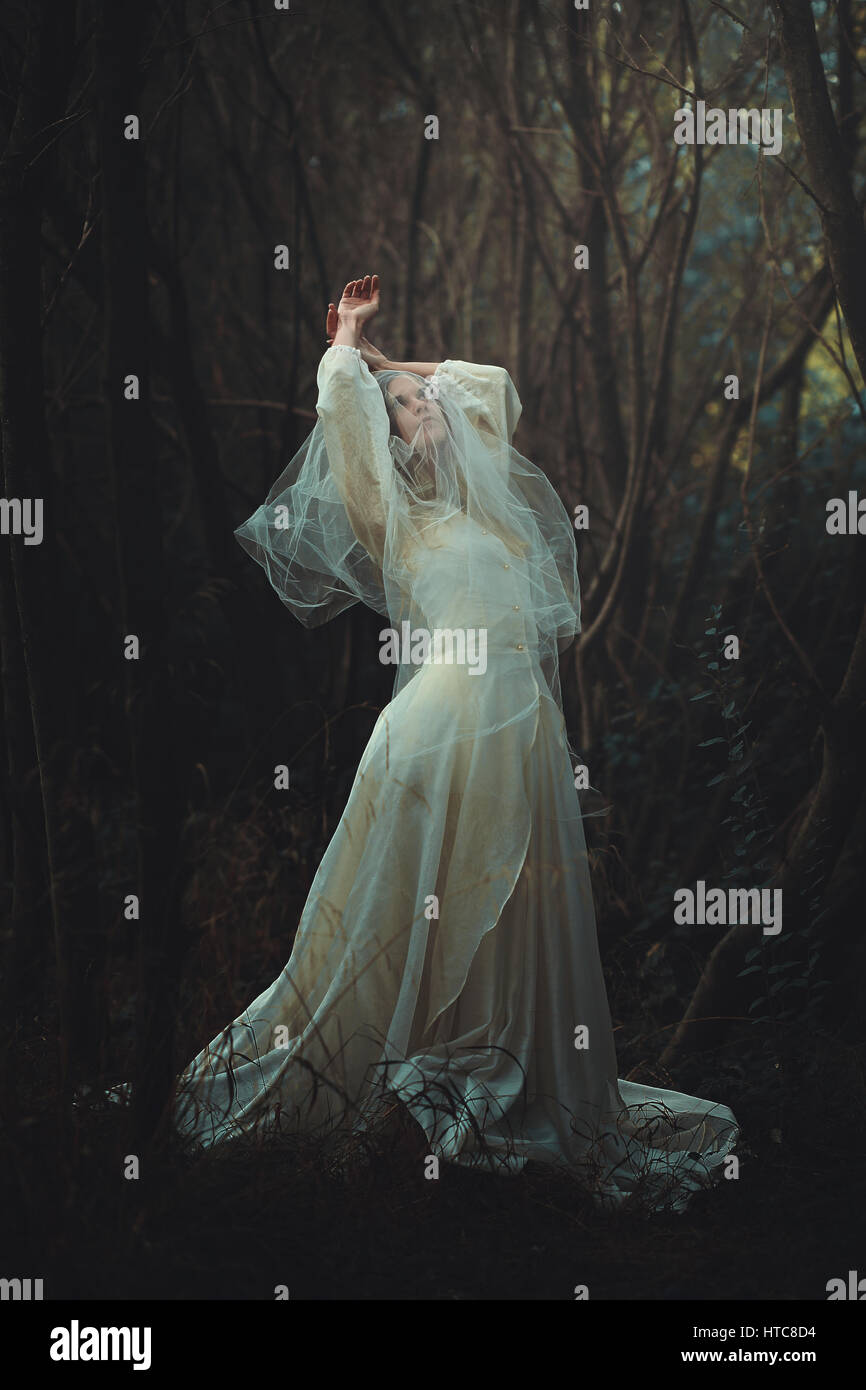 Sad bride with veil in the forest. Dark and surreal Stock Photo - Alamy