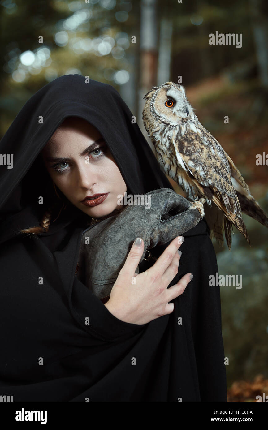Witch of the forest with her owl friend. Dark fantasy Stock Photo - Alamy