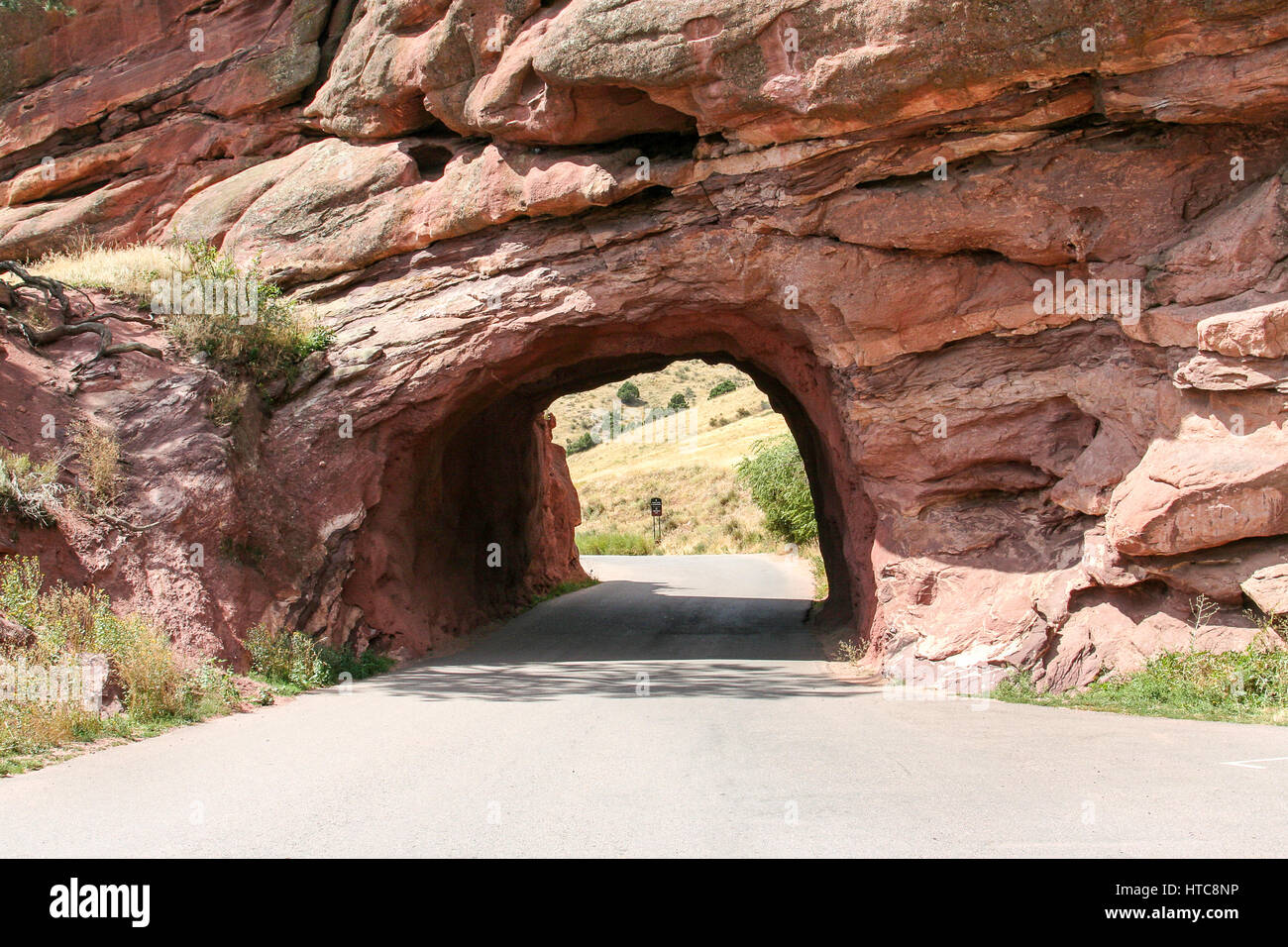 A tunnel in the rock formation at the Red Rocks State Park Stock Photo ...