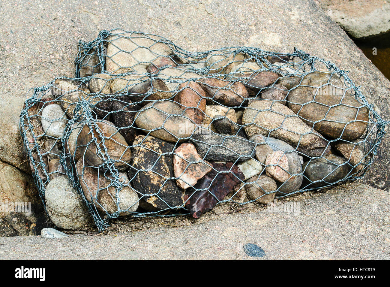 Close up of rocks in a wire netting Stock Photo - Alamy