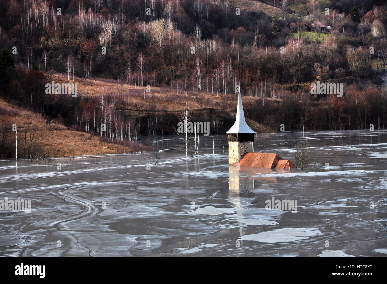 Abandoned church in a mud lake. Natural mining disaster with water ...