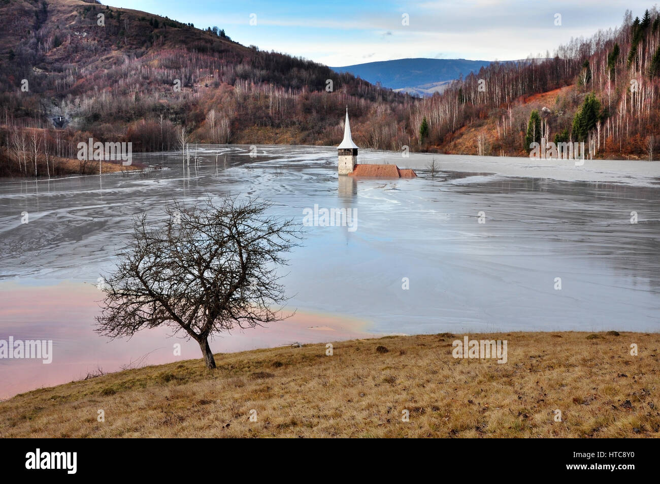 A flooded church in a toxic red lake. Water polluting by a copper mine ...