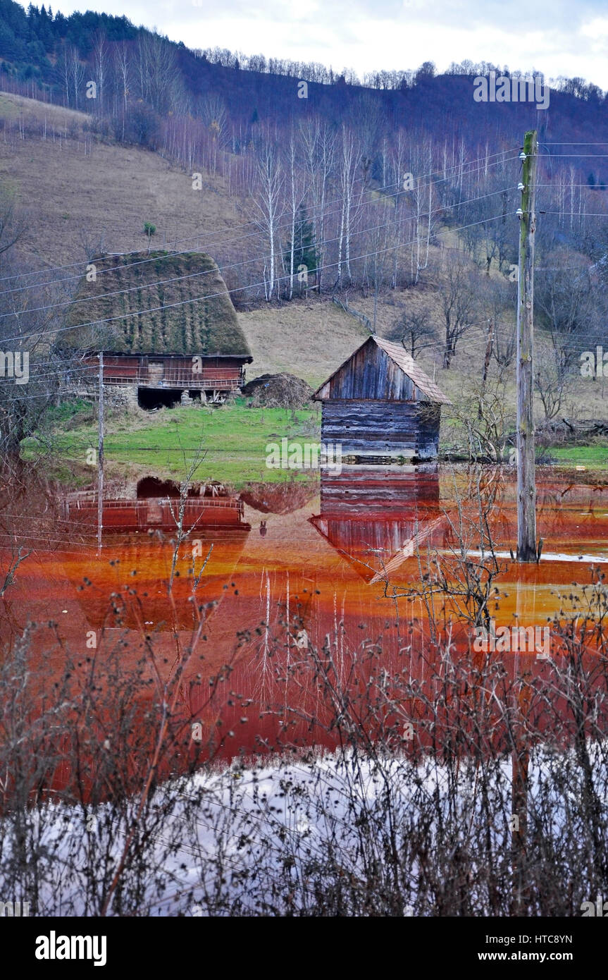 An abandoned house flooded by polluted water from a copper open cast ...