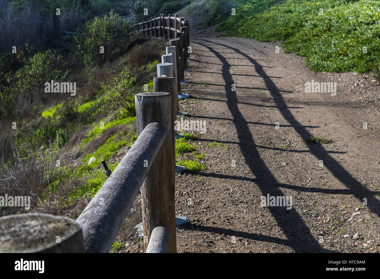 fence and shadows on dirt road Stock Photo - Alamy