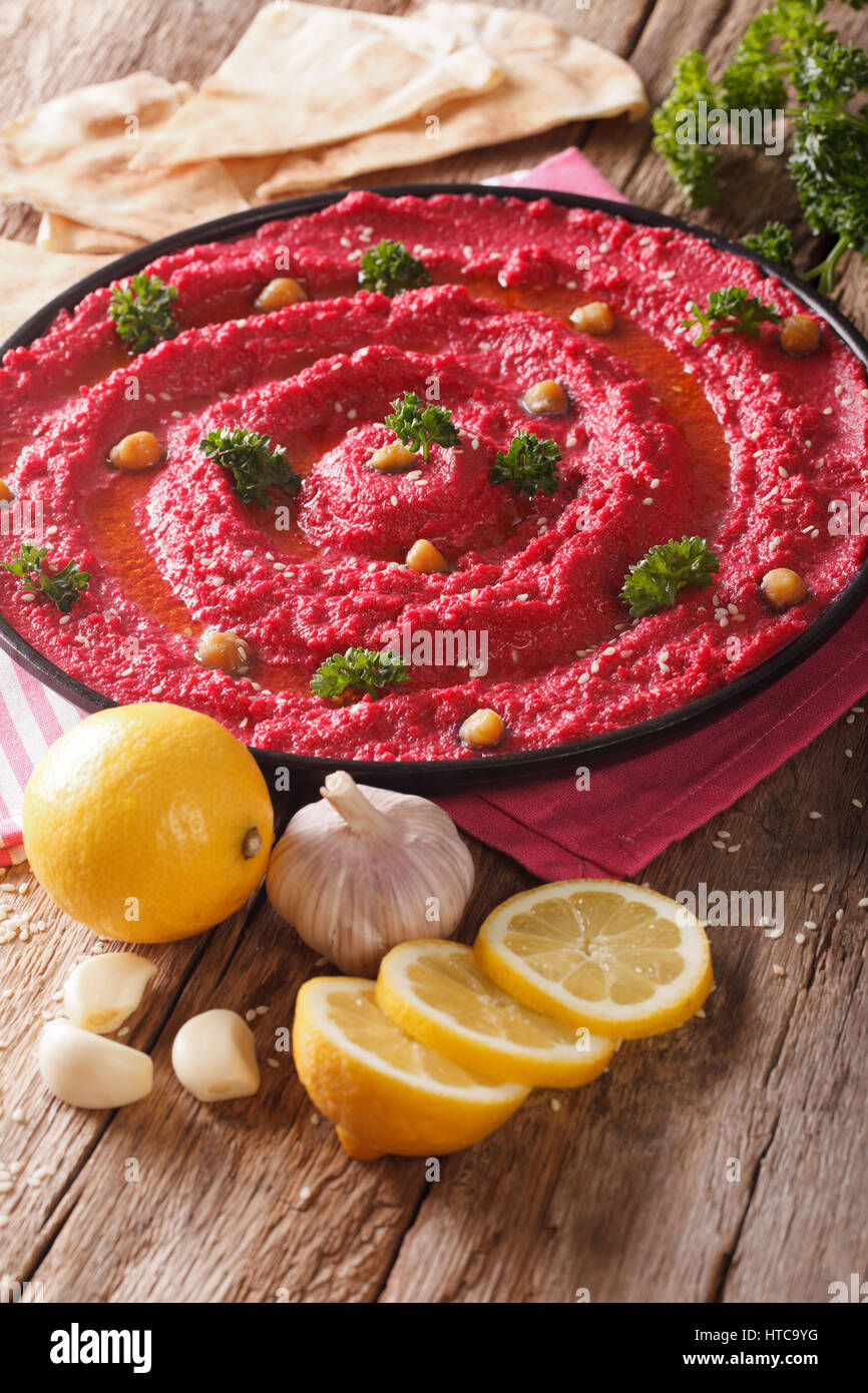 Hummus with beets and sesame close-up on the table. vertical Stock ...
