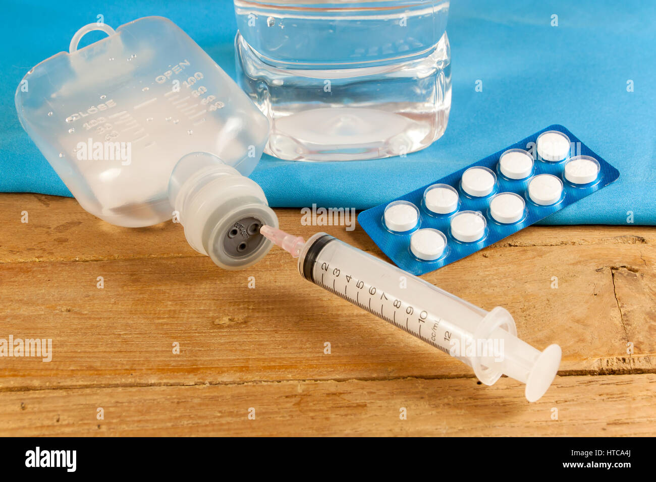 drug and saline solution and injection needle on wood table Stock Photo ...