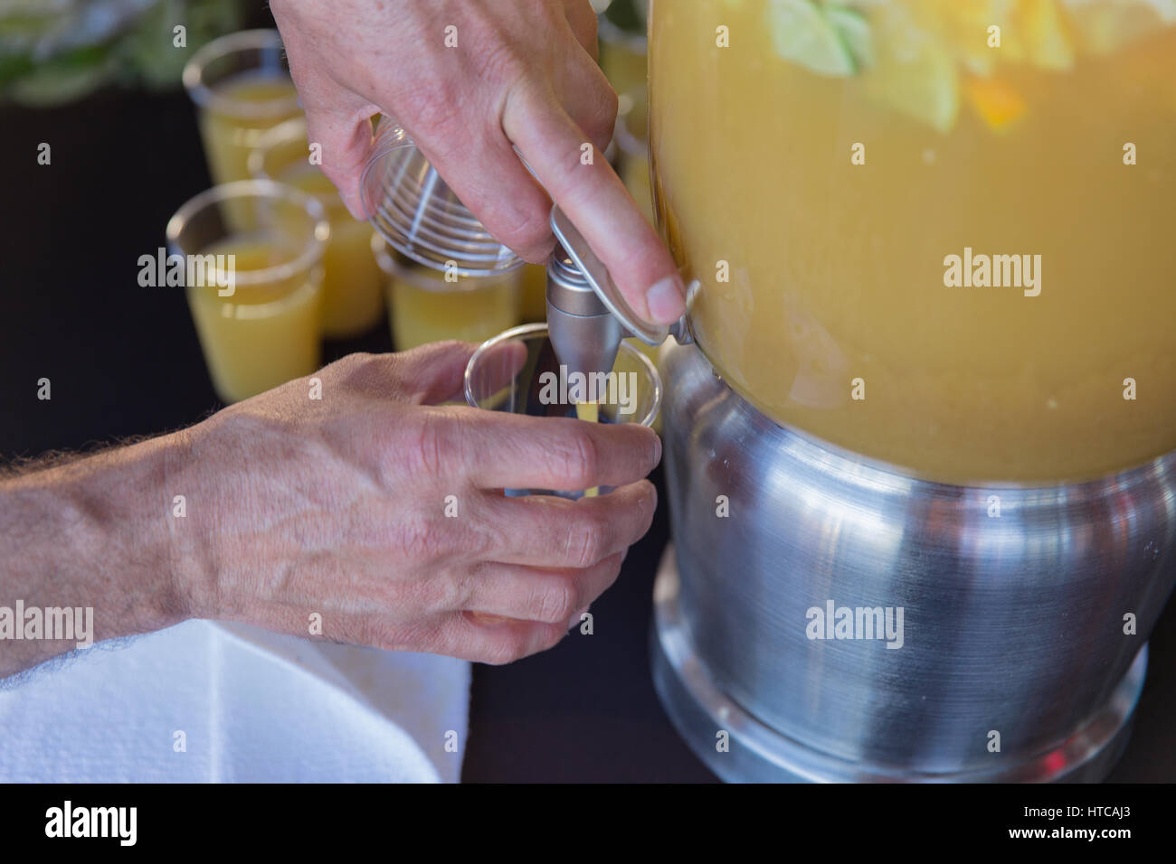 Man pouring lemonade into glass Stock Photo - Alamy