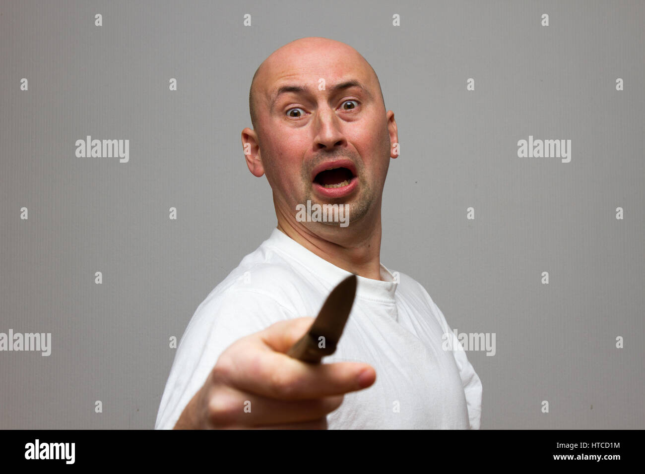 Enraged man with knife Stock Photo - Alamy