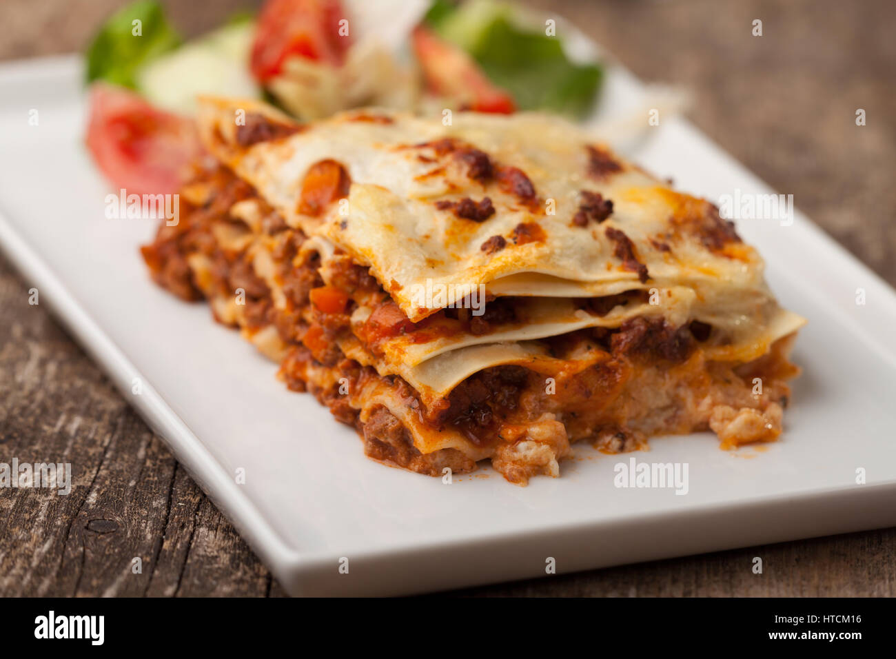 italian lasagna on a square plate Stock Photo - Alamy