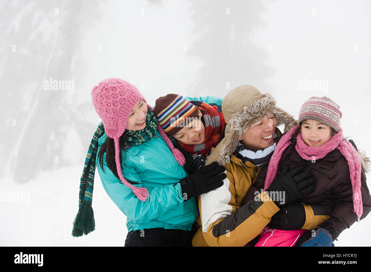 Family having fun in winter Stock Photo - Alamy