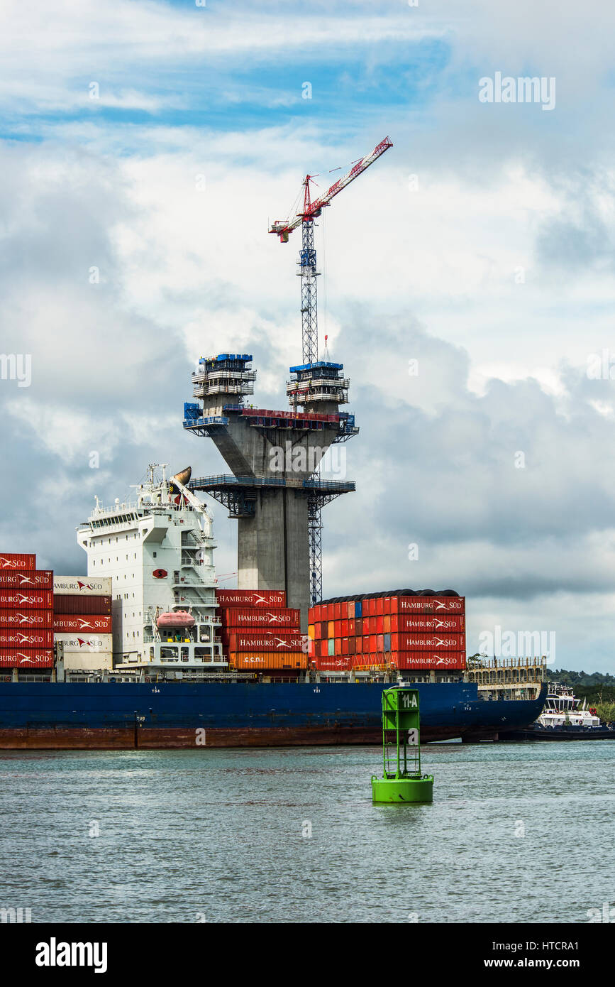 A freighter passing below the construction under the third Panama Canal ...