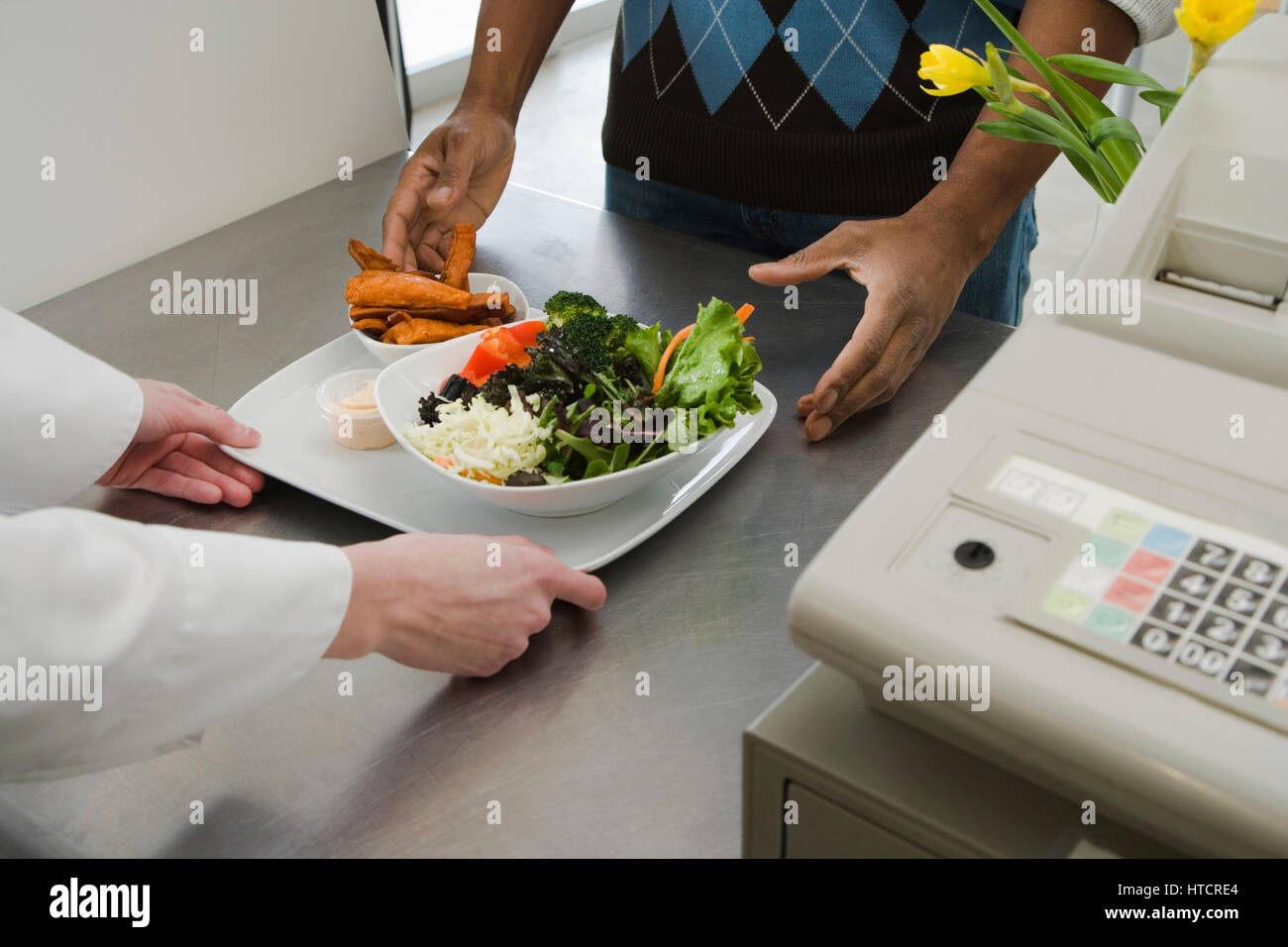 Man buying meal in cafe Stock Photo - Alamy