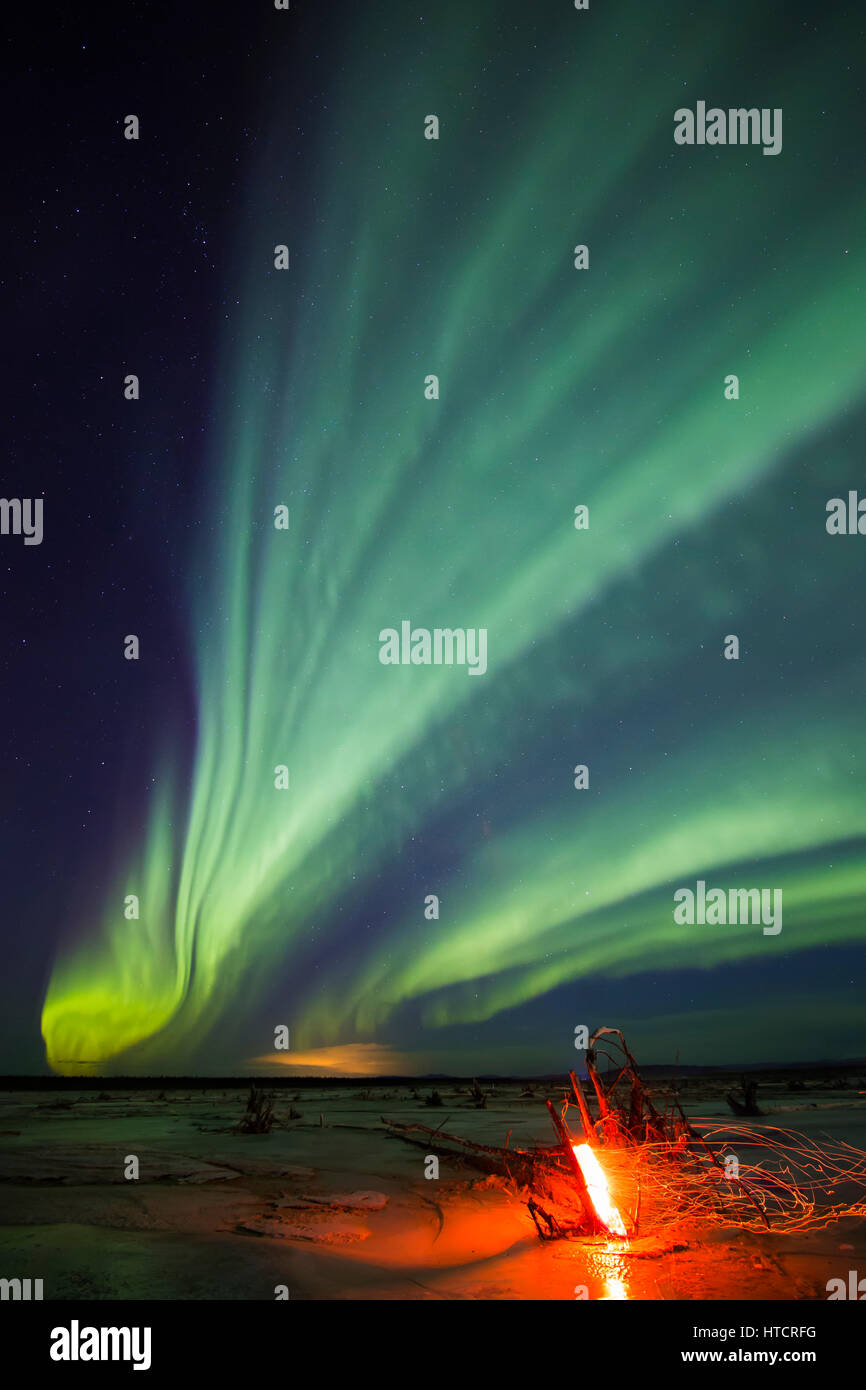 Wind blows sparks from a fire on the frozen Delta River near Delta ...