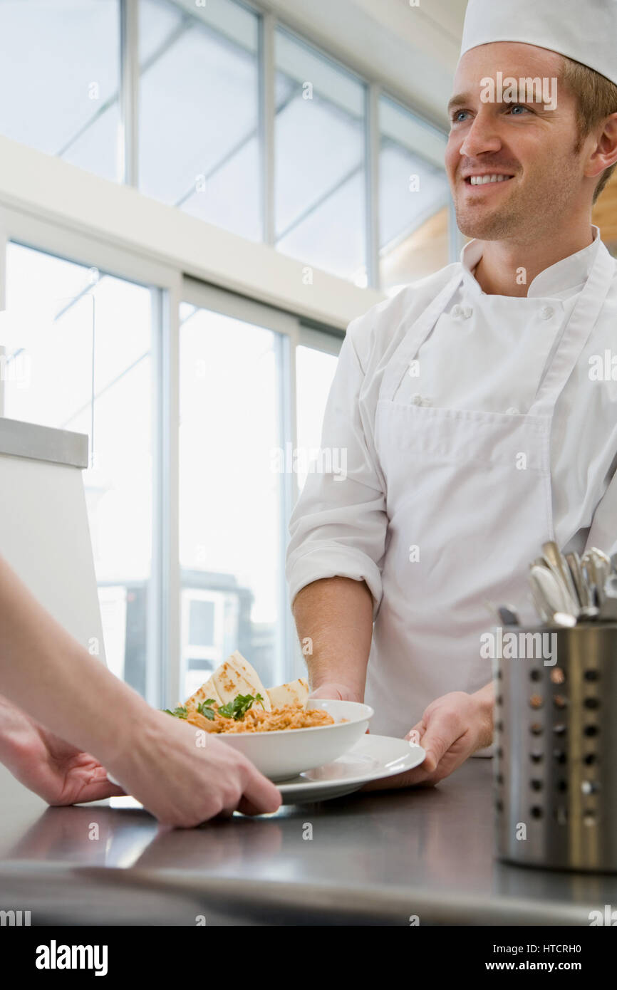 Chef with meal Stock Photo - Alamy