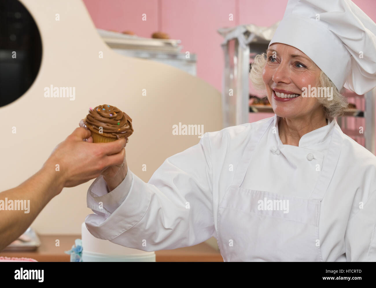 Chef with cupcake Stock Photo - Alamy