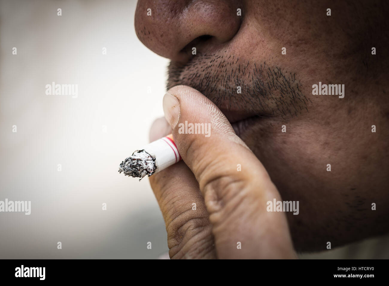 Hands holding cigarette with jeans background, no smoking campaign ...