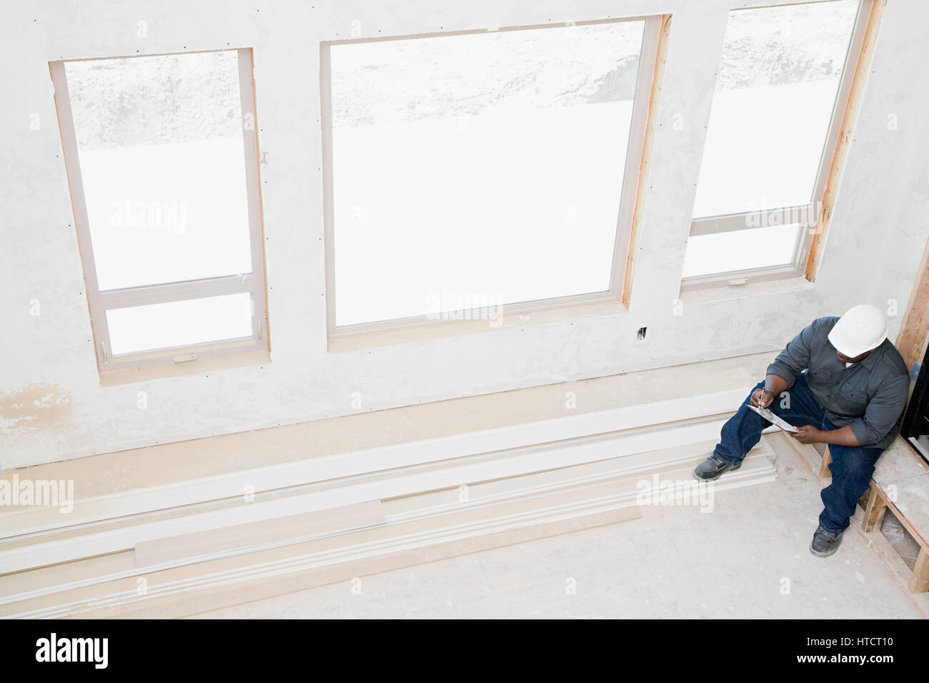 A builder inspecting a house Stock Photo - Alamy
