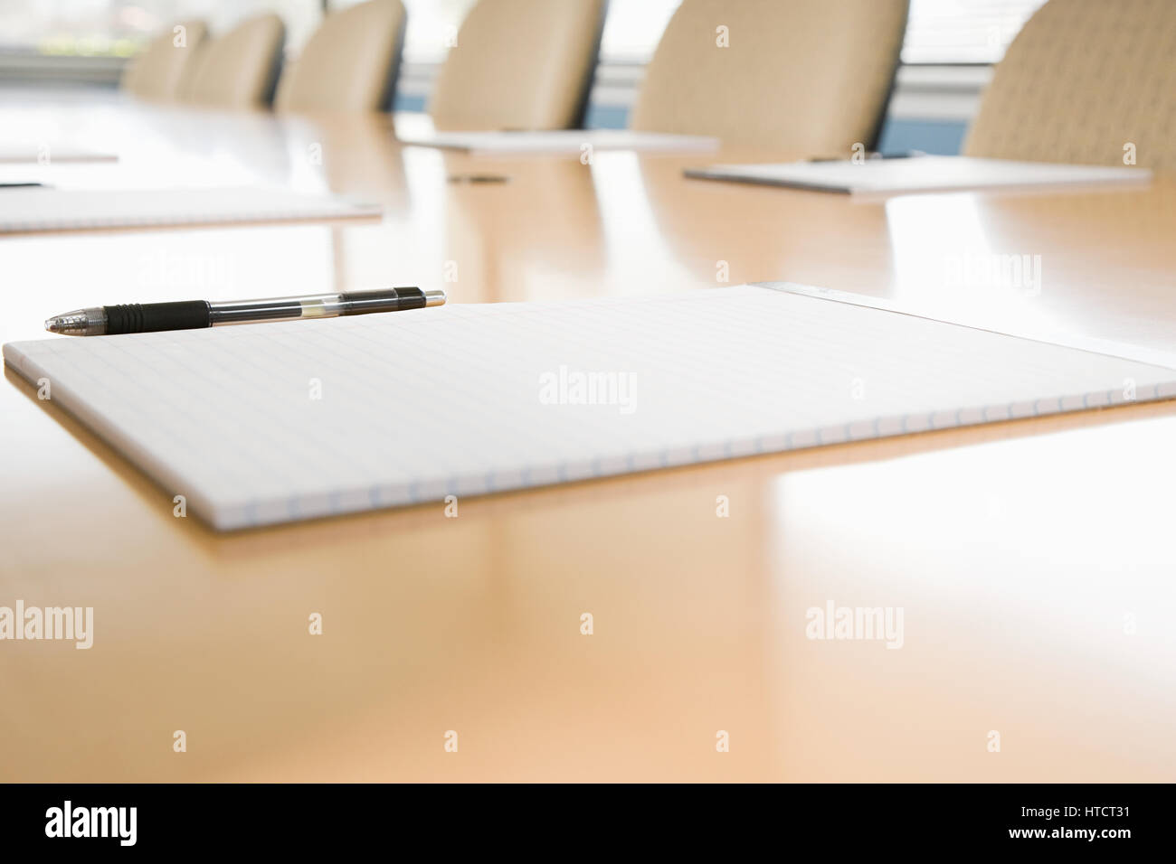 Notepads on conference table Stock Photo - Alamy
