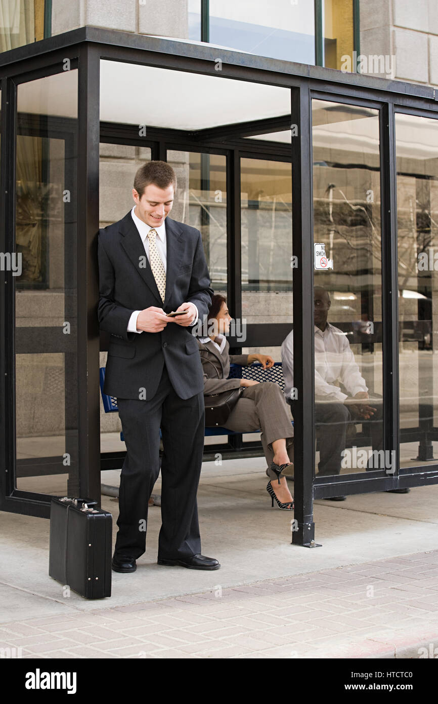 People waiting at bus stop Stock Photo - Alamy