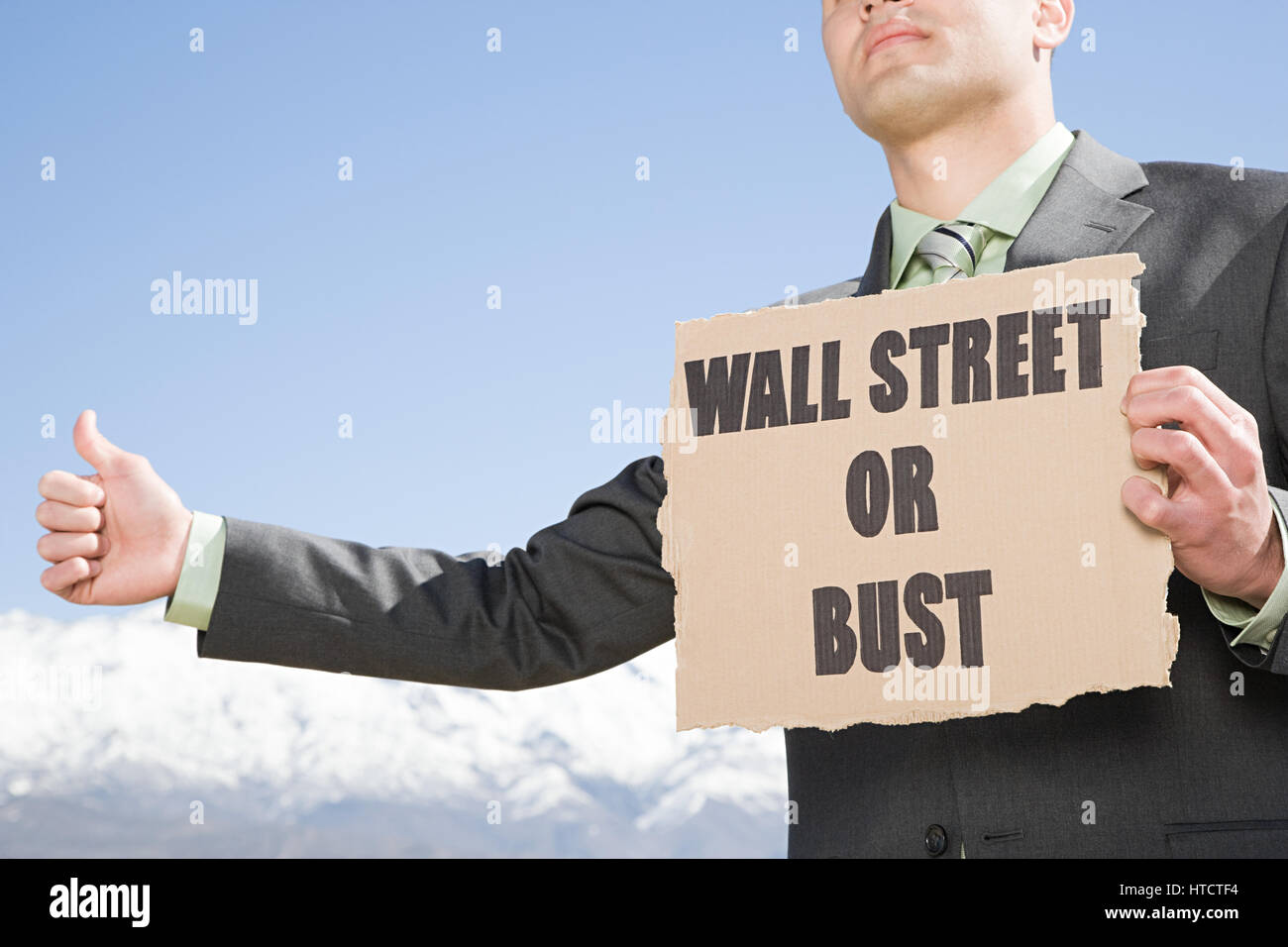 Businessman hitching a ride Stock Photo - Alamy