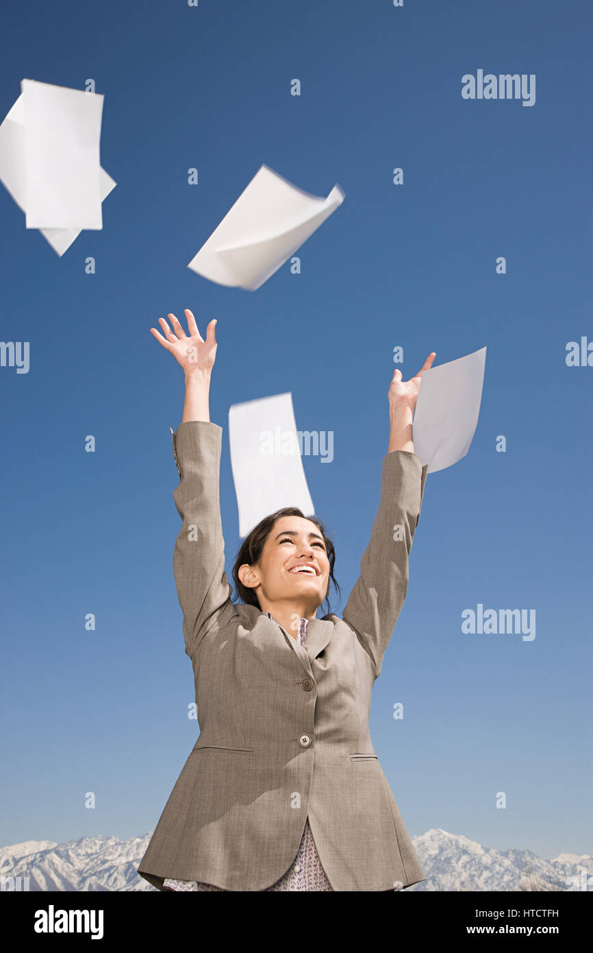 Woman throwing paper Stock Photo - Alamy