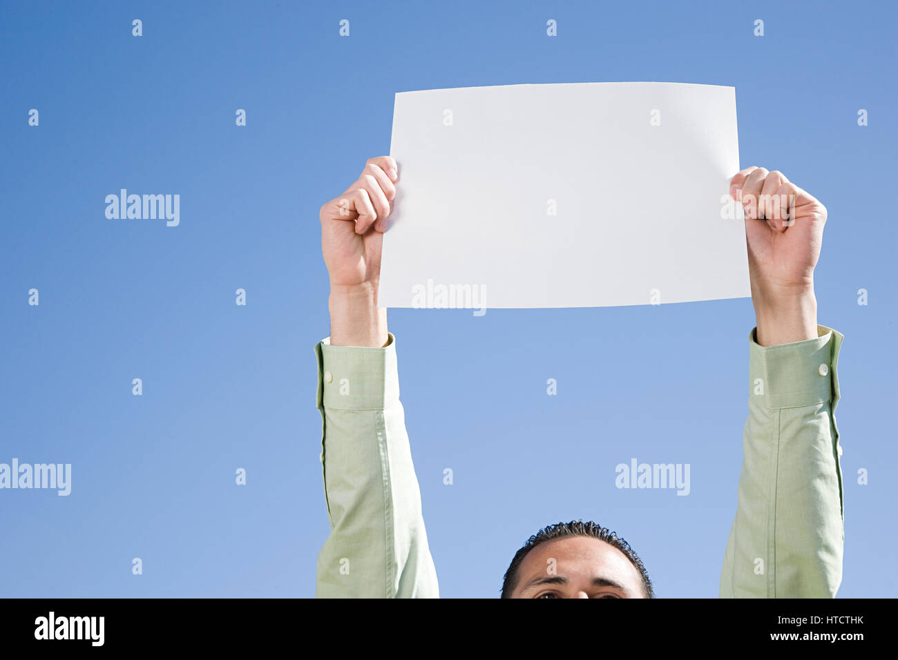 Man holding piece of paper Stock Photo - Alamy