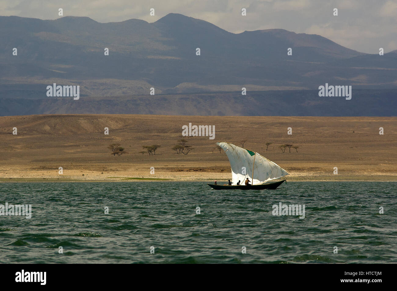 Fisherman in a traditional canoe plowing through the waters of the ...